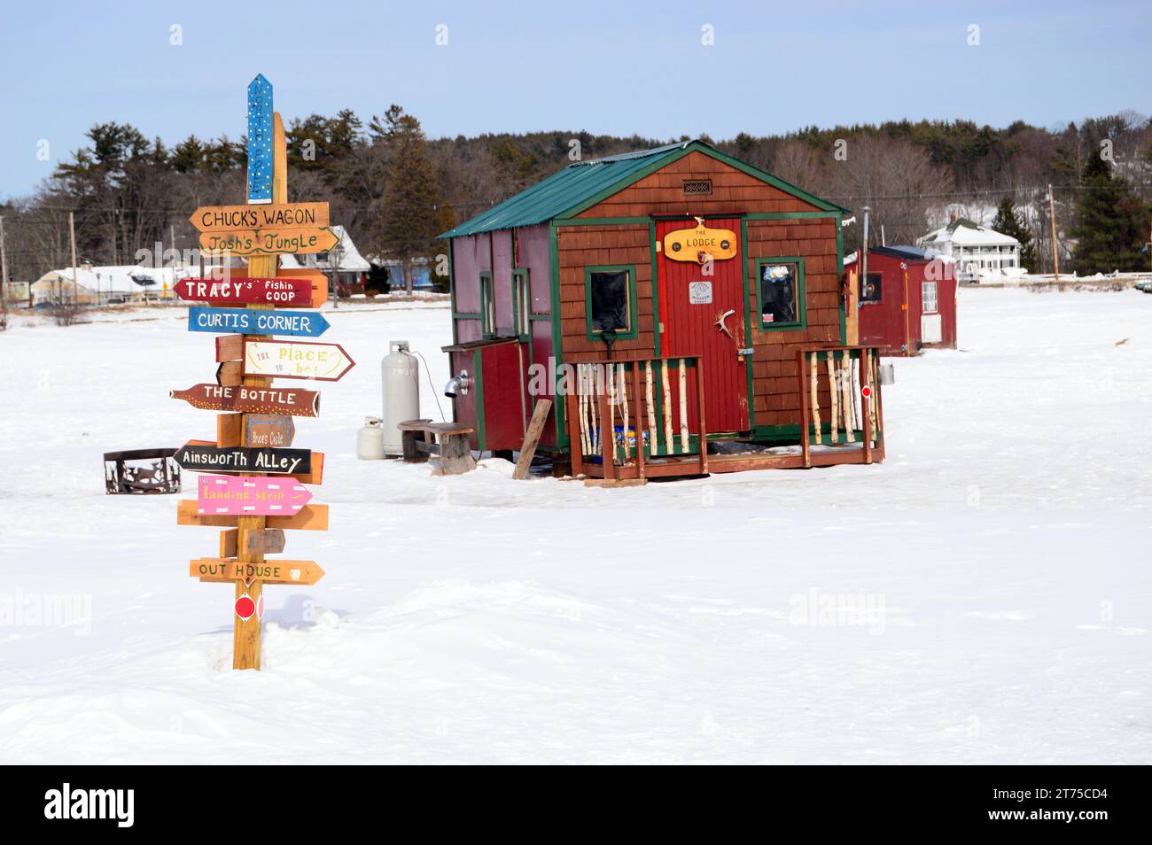 Signs and Ice Fishing huts and Shacks stand on a Frozen Lake Squam, New ...