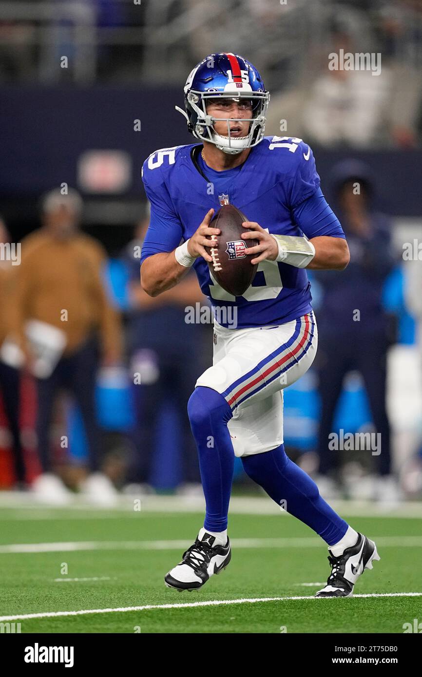 New York Giants quarterback Tommy DeVito (15) rolls out of the pocket ...