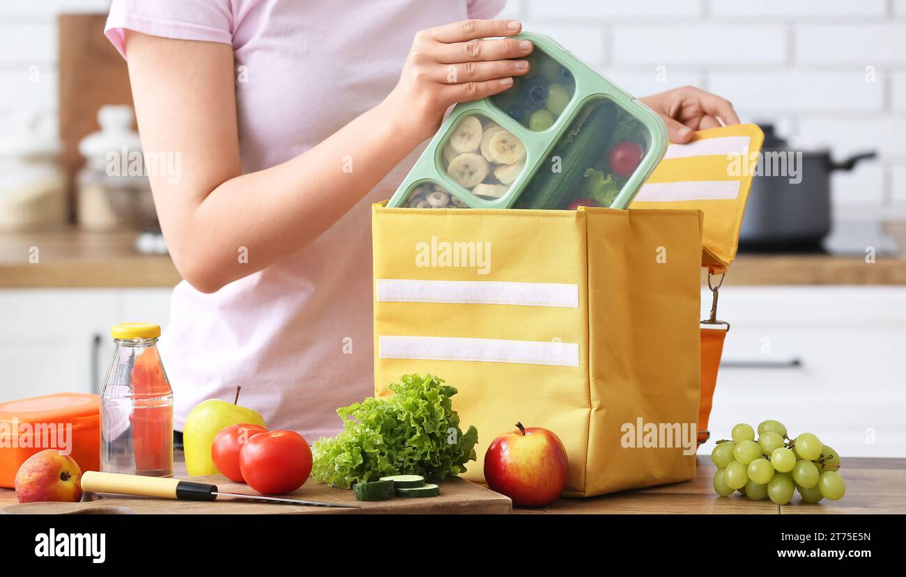 Woman packing school lunch for her child in kitchen Stock Photo - Alamy