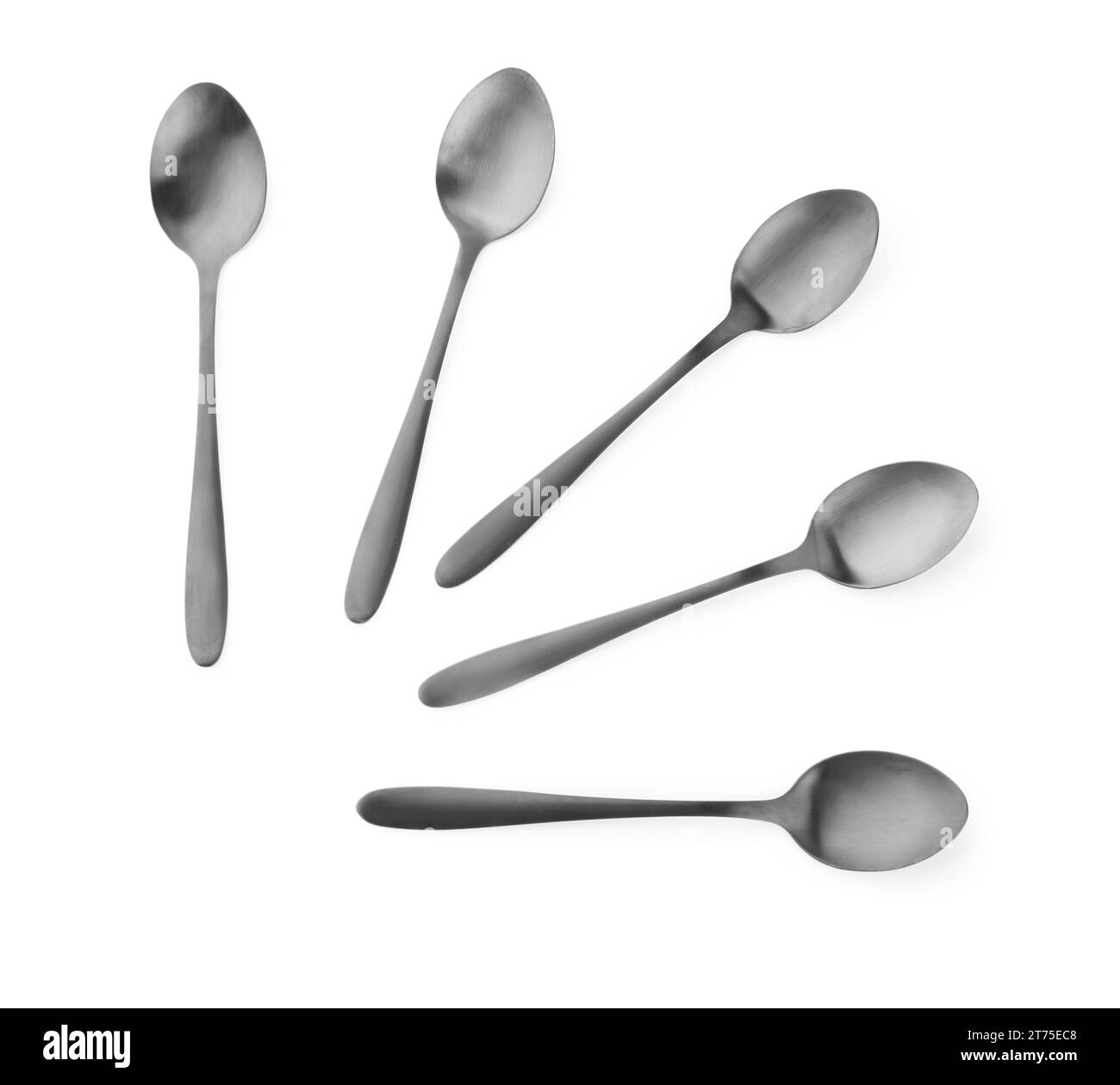 Stainless steel spoons on white background Stock Photo - Alamy