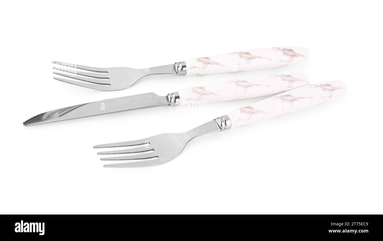 Stainless steel forks and knife with plastic handles on white ...