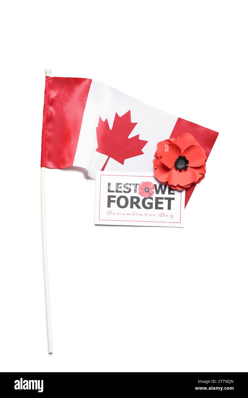 Poppy flower, flag of Canada and card with text LEST WE FORGET on white ...