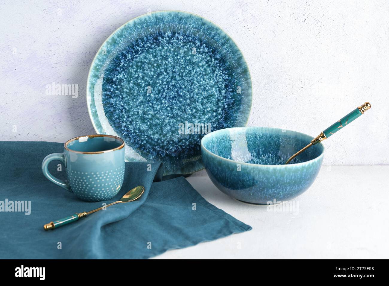 Set of clean blue dishes on white table Stock Photo - Alamy