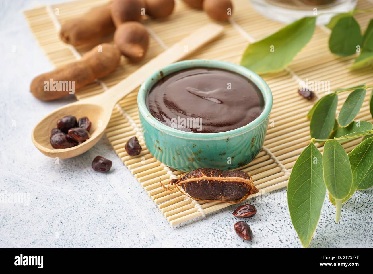 Bowl with tasty tamarind jam with fruits on white background Stock ...