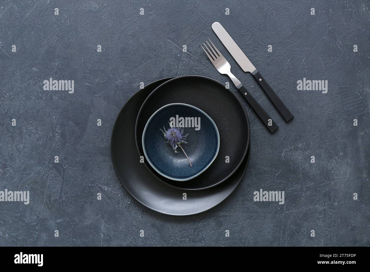 Stylish table setting on black background Stock Photo - Alamy