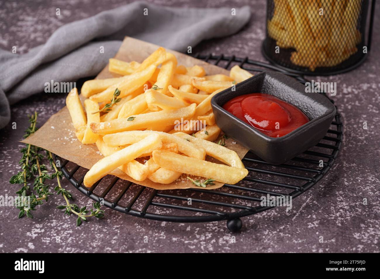 Grid with tasty french fries and ketchup on grey background Stock Photo ...