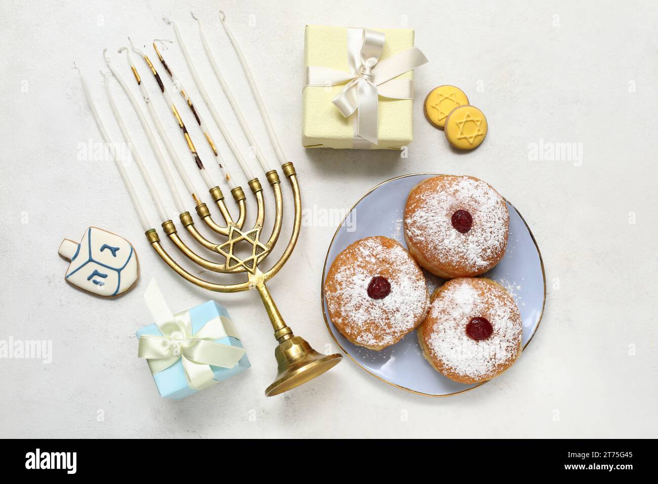 Composition with Menorah, gifts and tasty donuts for Hanukkah ...