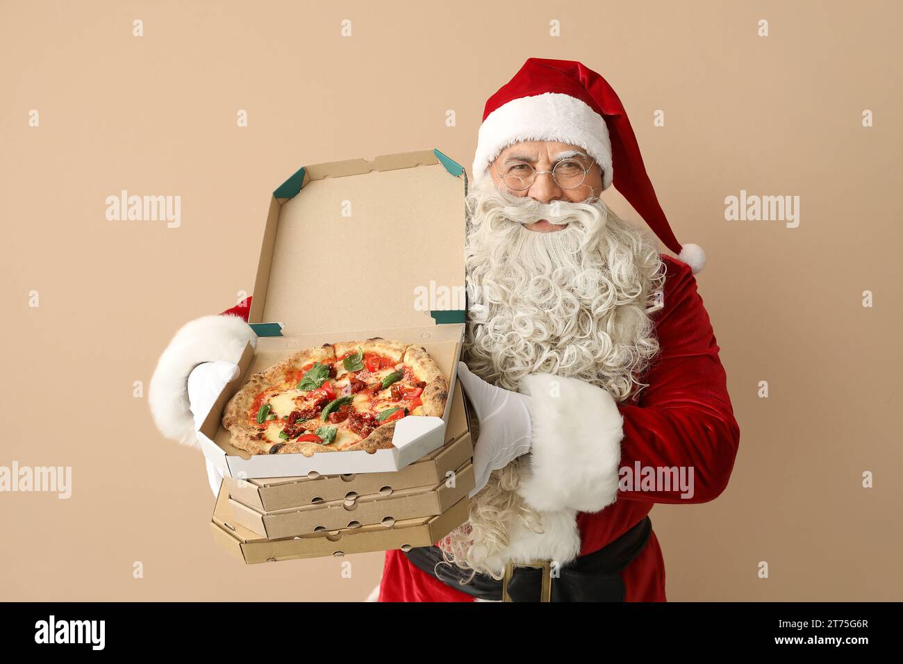 Santa Claus with boxes of tasty pizza on beige background Stock Photo ...