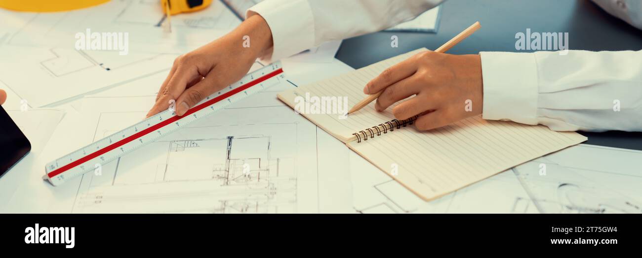 Architect or engineer working on building blueprint, contractor ...