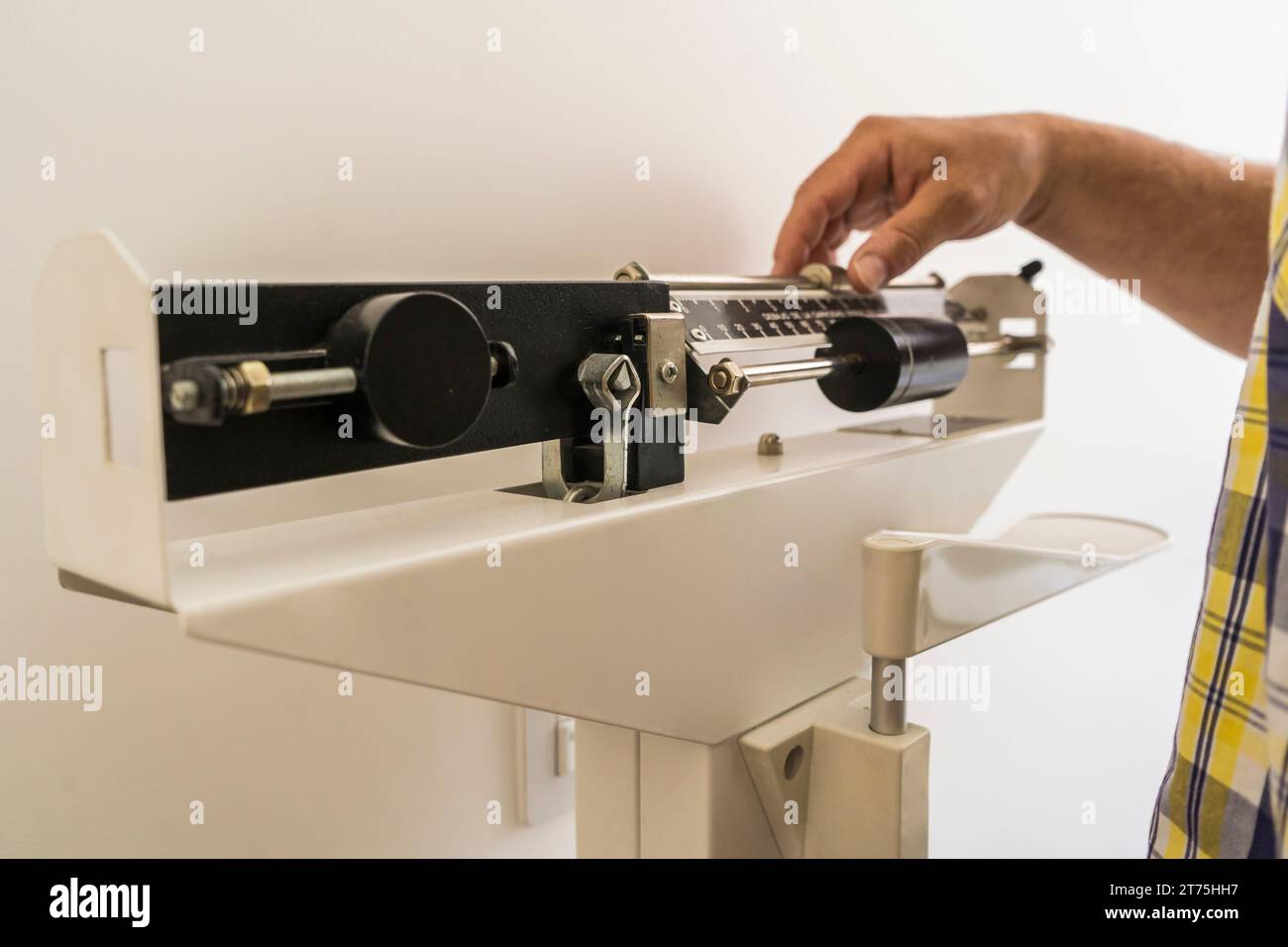 Close-up of man on weighing scale in nutritionist's office Stock Photo ...