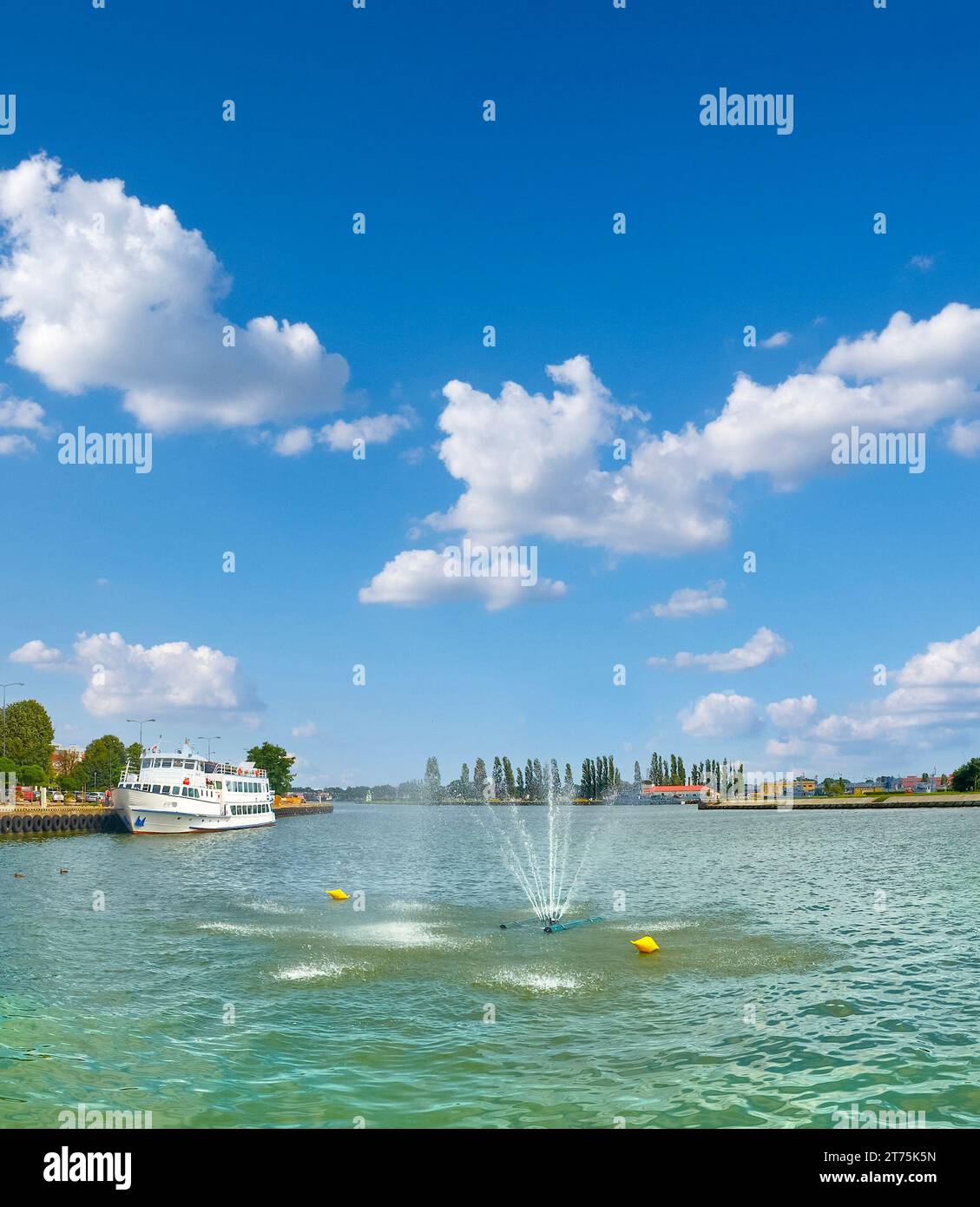 River fountain and river passenger boat in Swina river in Swinoujscie ...