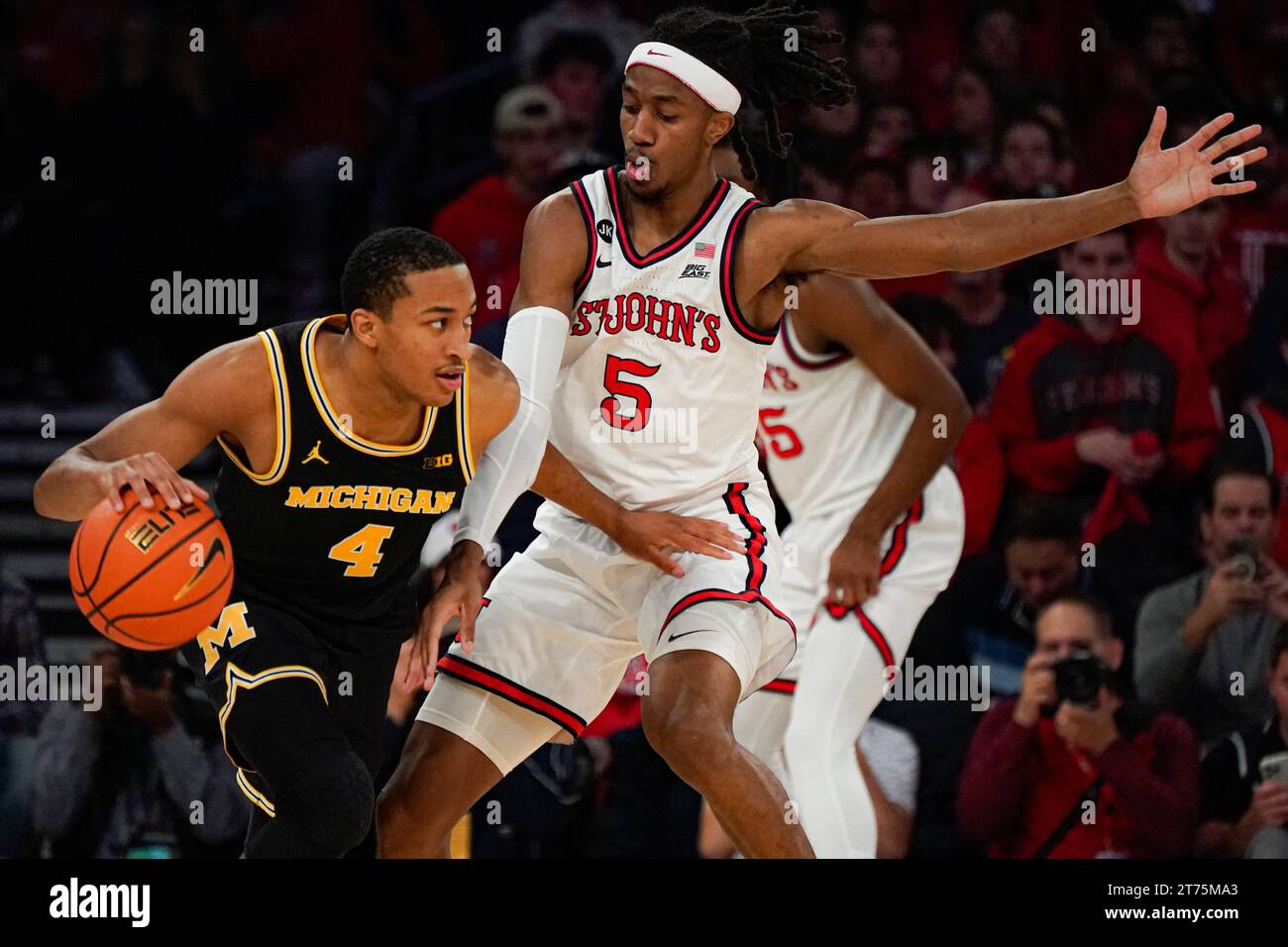 St. John's guard Daniss Jenkins (5) defends Michigan guard Nimari ...