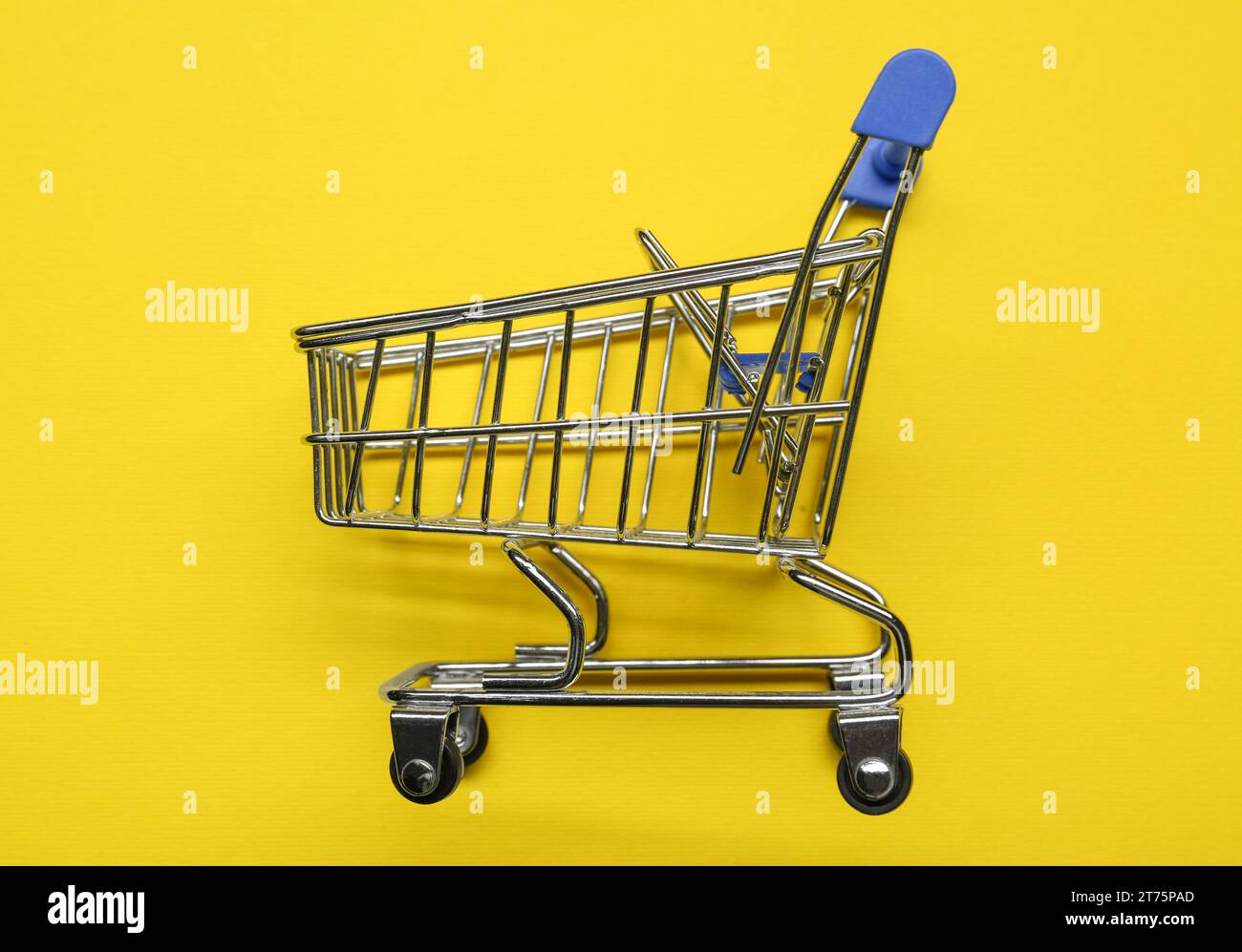 Small metal shopping cart on yellow background, top view Stock Photo ...