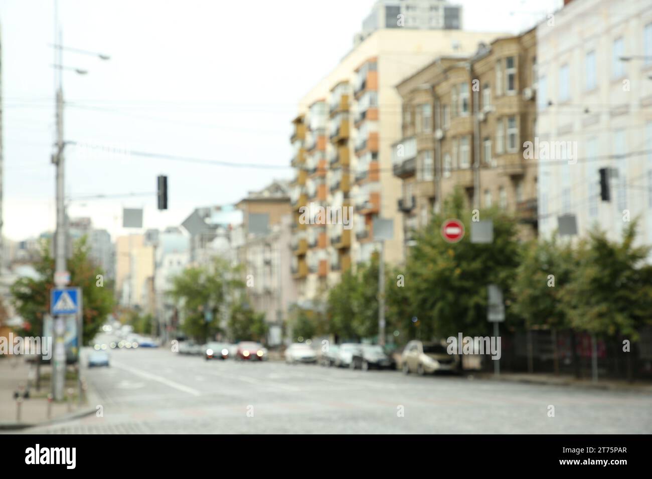 Blurred view of quiet city with buildings and cars on road Stock Photo ...