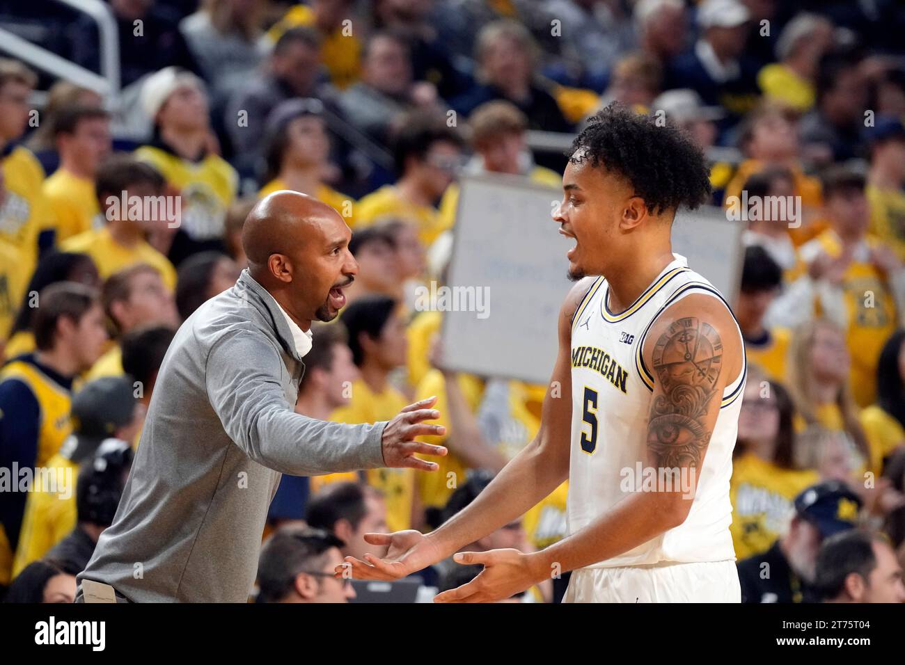 Michigan assistant coach Saddi Washington talks to forward Terrance ...