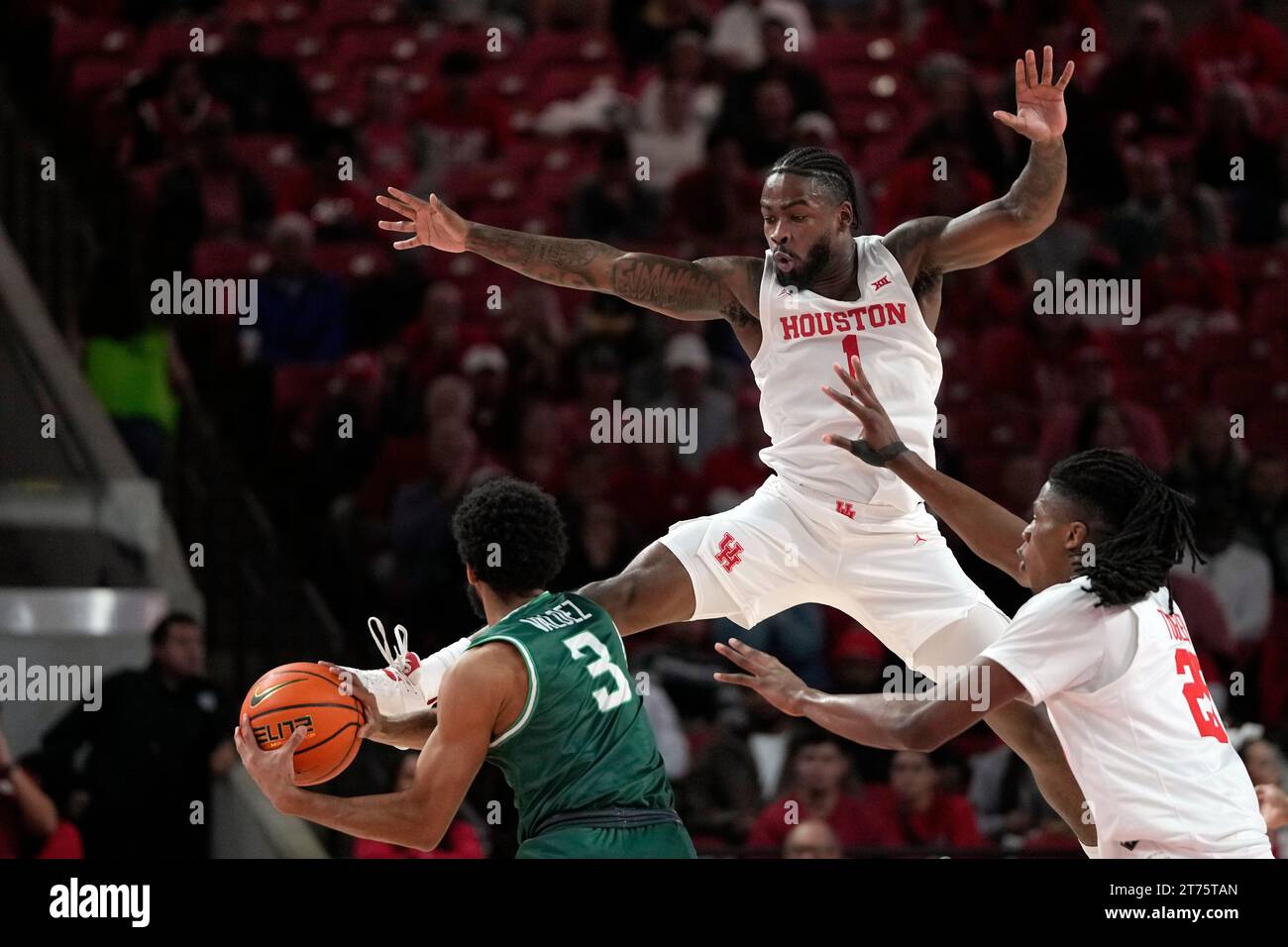 Houston's Jamal Shead (1) and Joseph Tugler (25) defend against Stetson ...