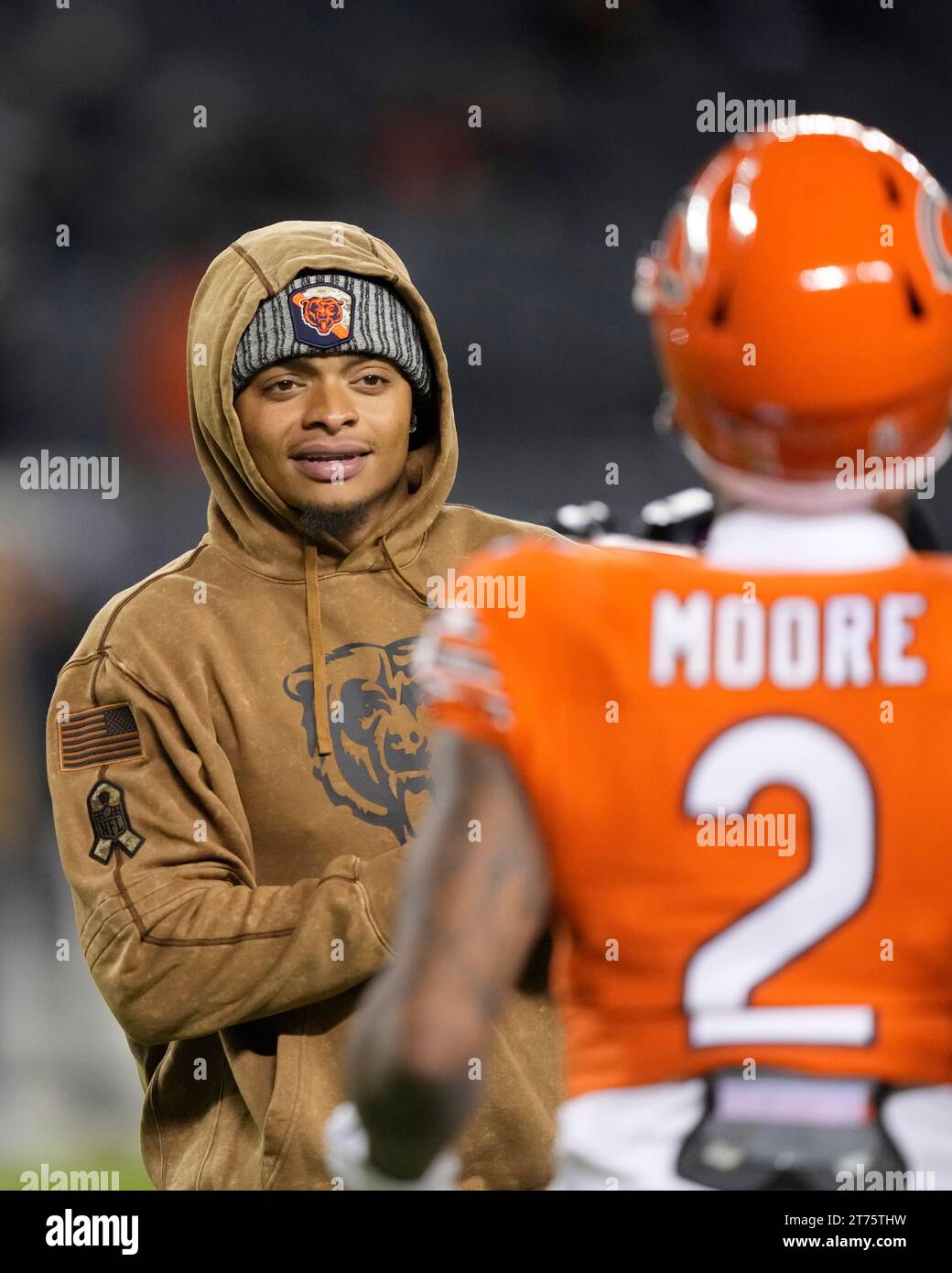 Injured Chicago Bears quarterback Justin Fields talks to wide receiver ...