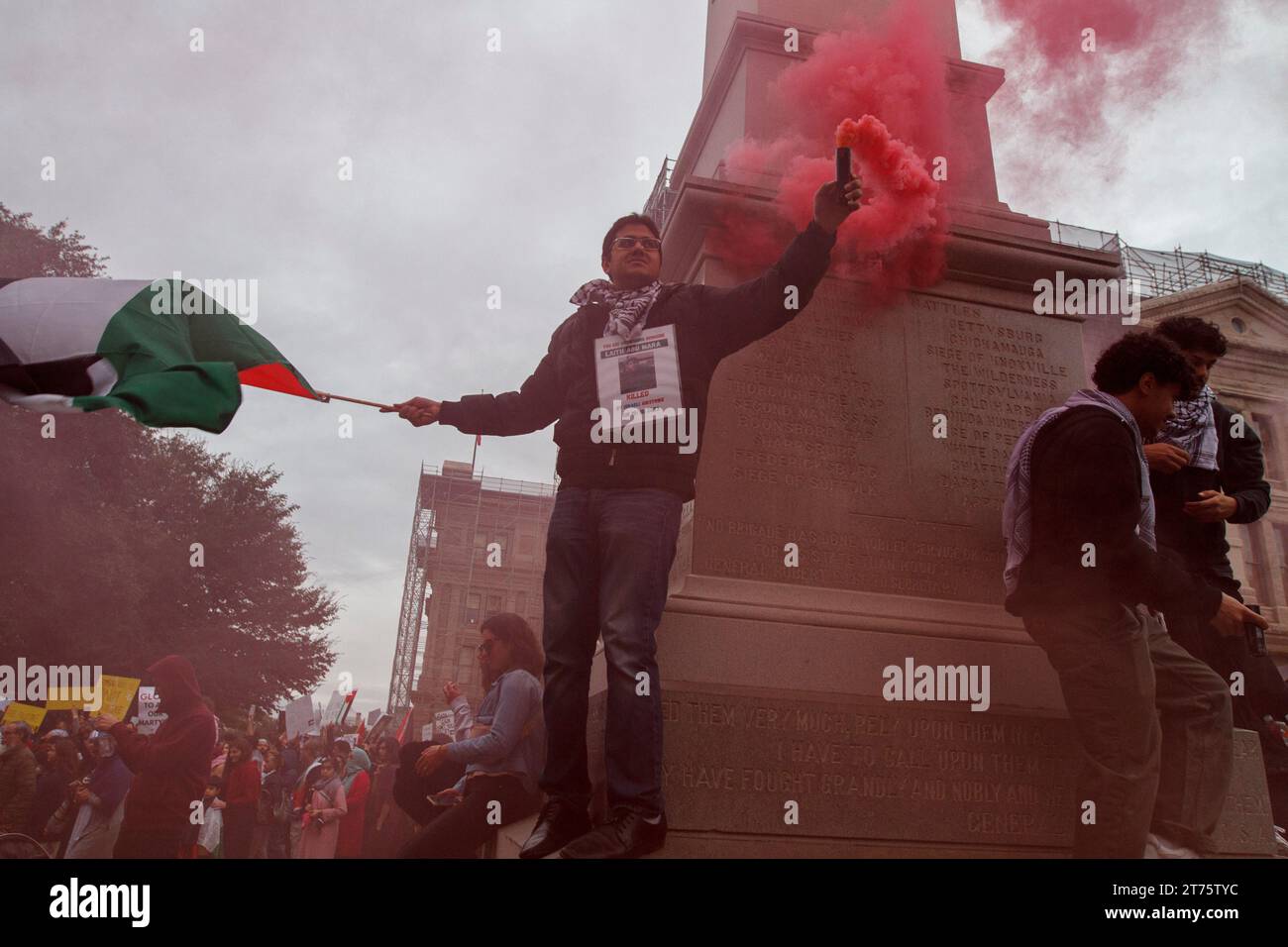 Austin, Texas, USA. 12th Nov, 2023. A protestor holds a smoke bomb ...