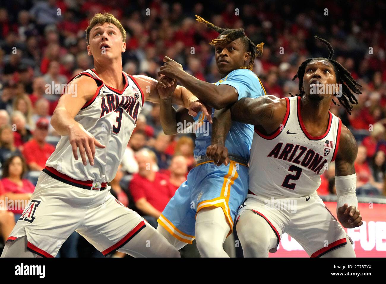 Arizona guard Pelle Larsson (3) and guard Caleb Love (2) box out Southern University guard ...