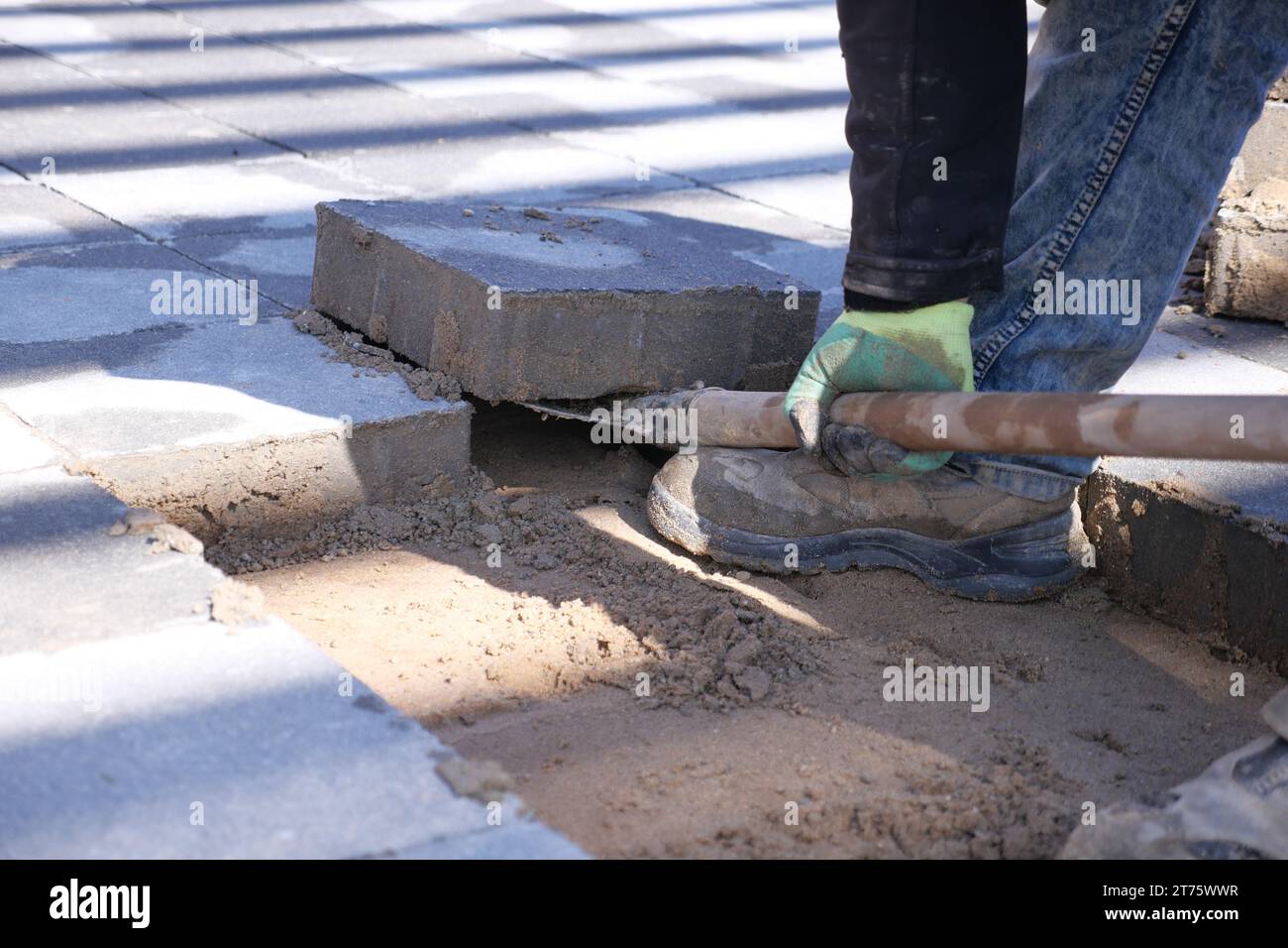 Worker remove large concrete blocks on a sandy surface Stock Photo - Alamy