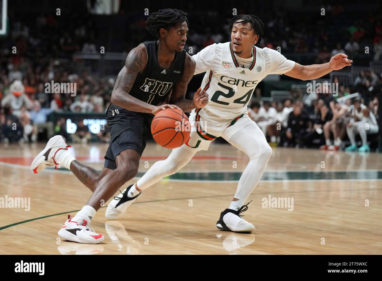 Florida International guard Dashon Gittens (1) drives past Miami guard ...
