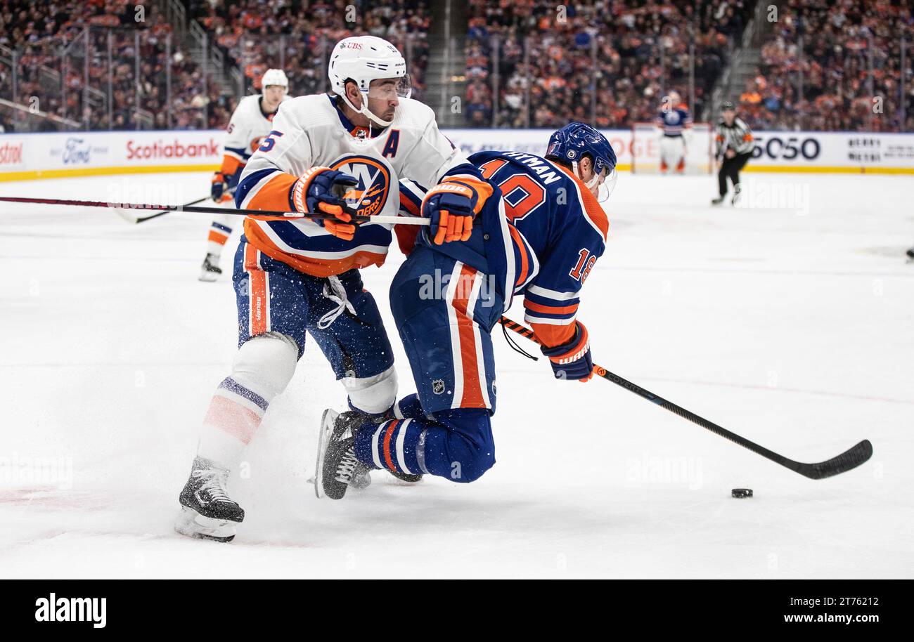New York Islanders' Cal Clutterbuck (15) checks Edmonton Oilers' Zach ...