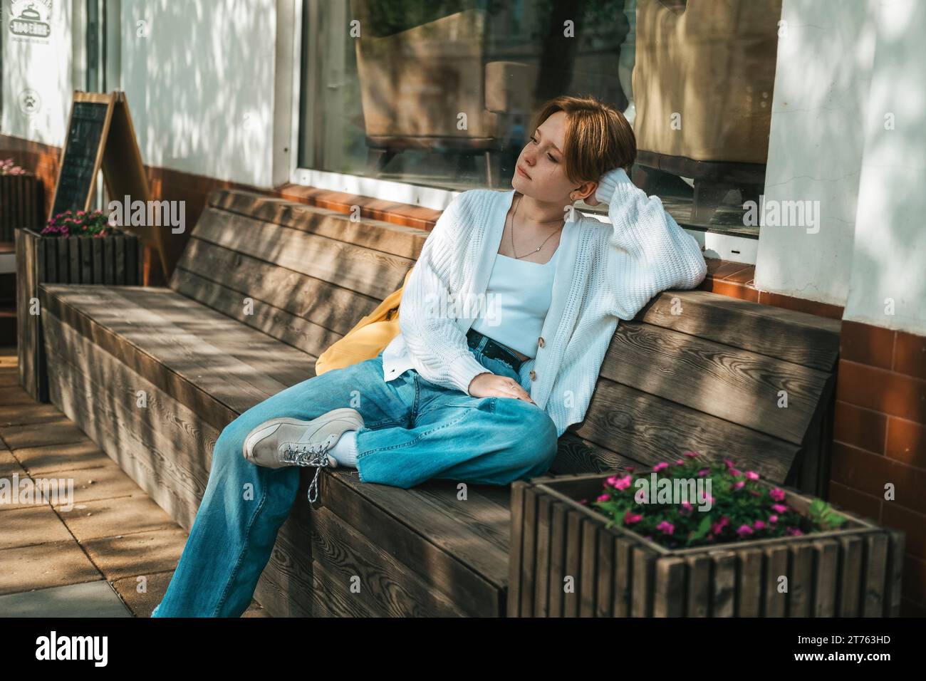 Urban backdrop frames a trendy teenage girl, her short, fiery hair and ...