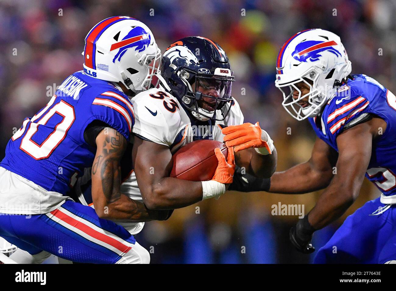Denver Broncos' Javonte Williams, center, runs the ball during the ...