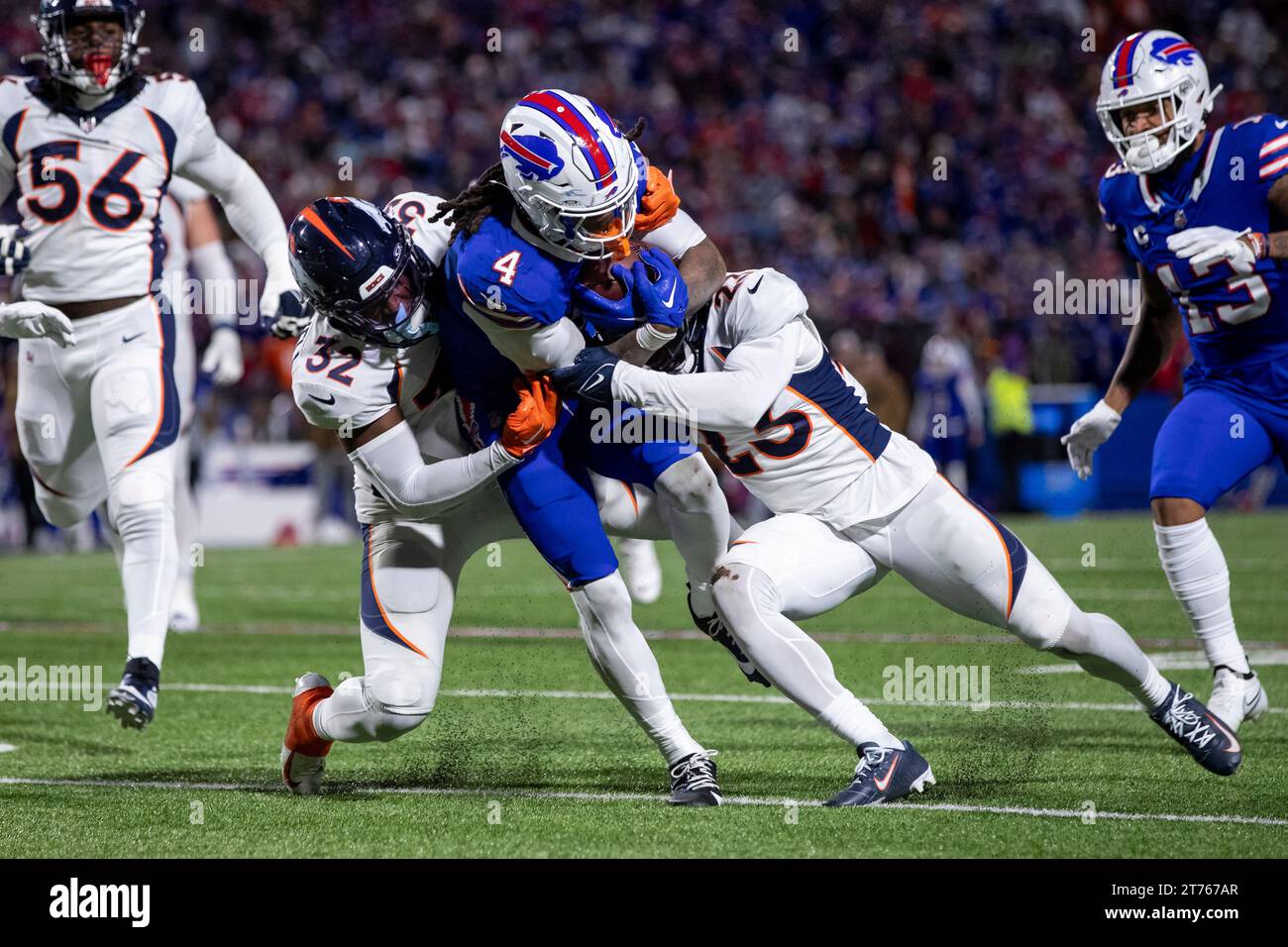 Buffalo Bills running back James Cook (4) is tackled by Denver Broncos ...