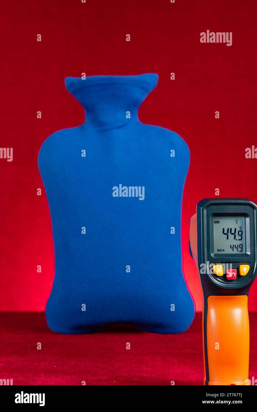 infrared thermometer shows the surface temperature of a hot water ...