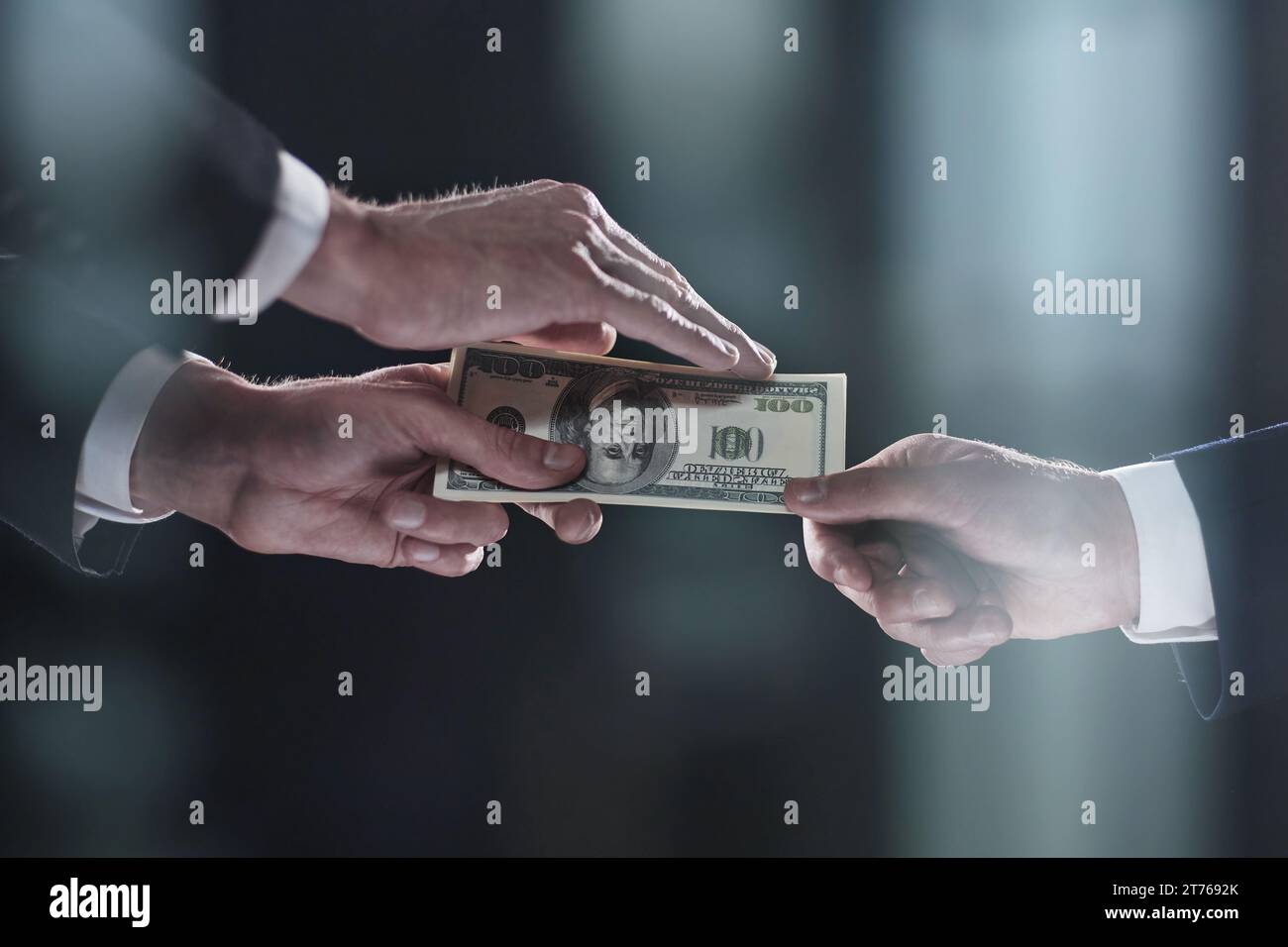 transferring money from hand to hand on a black background Stock Photo ...