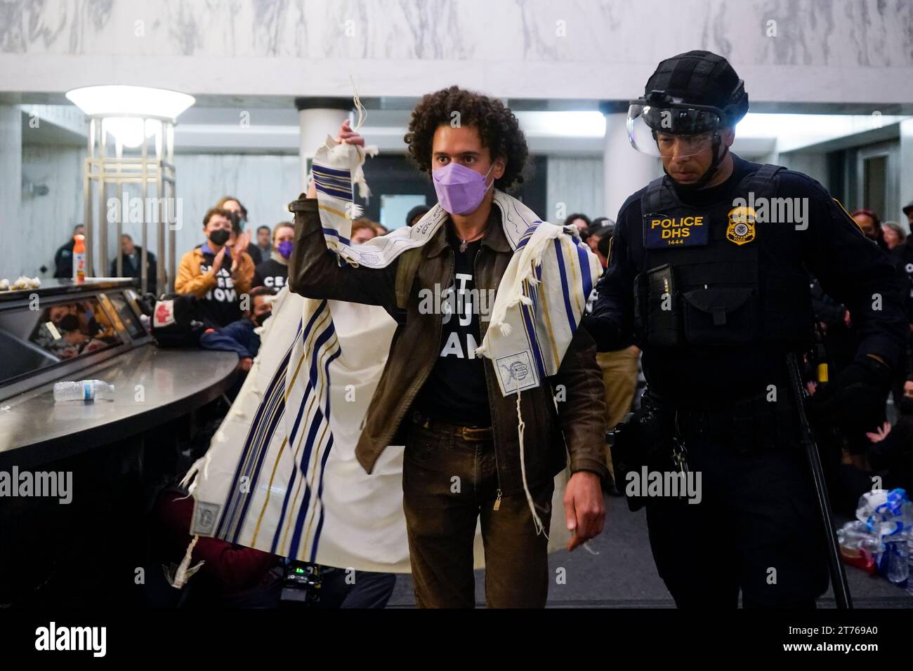 A Department of Homeland Security officer detains a protester during a ...
