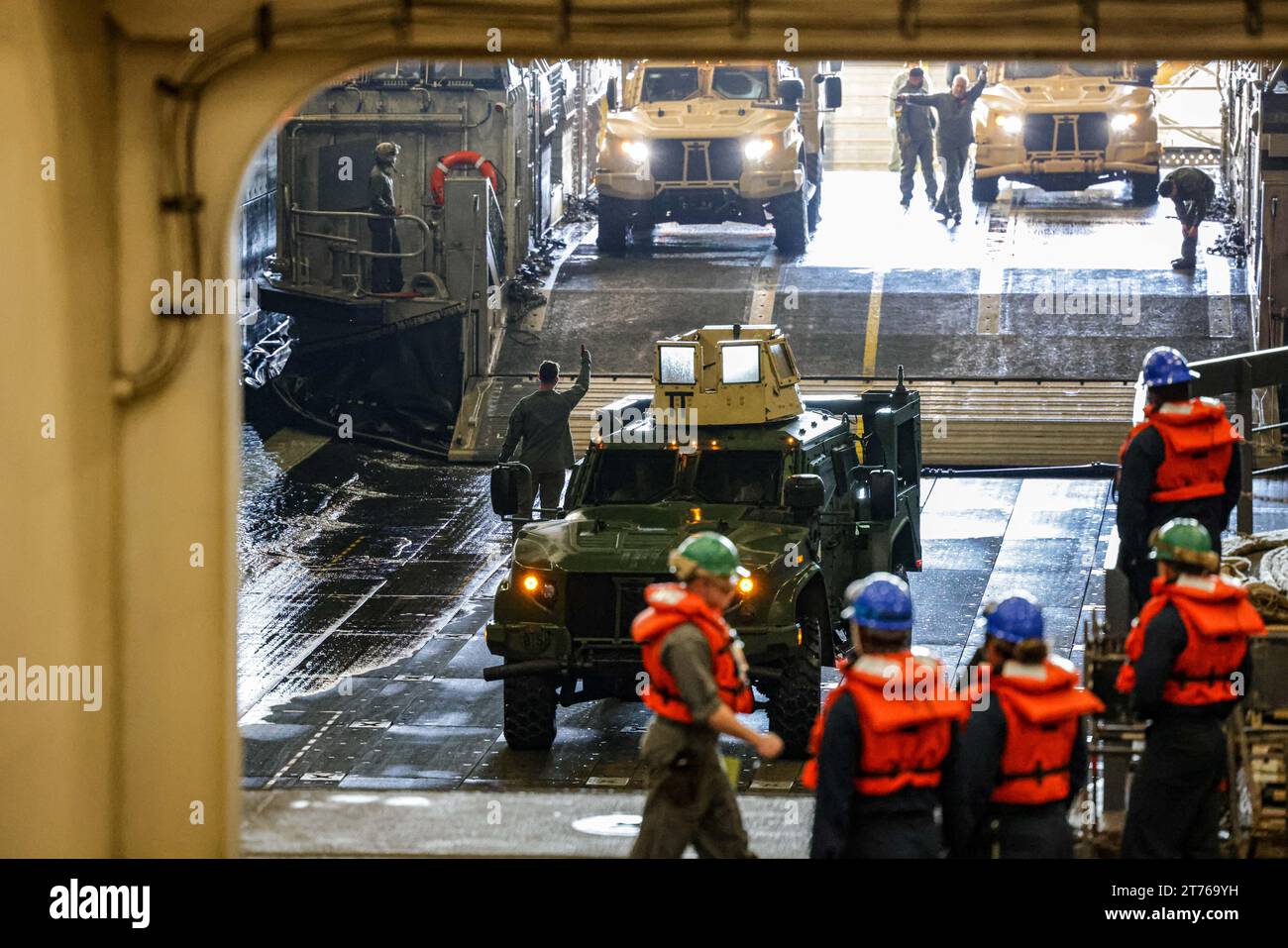U.S. Marine Corps Joint Light Tactical Vehicles are loaded into the ...