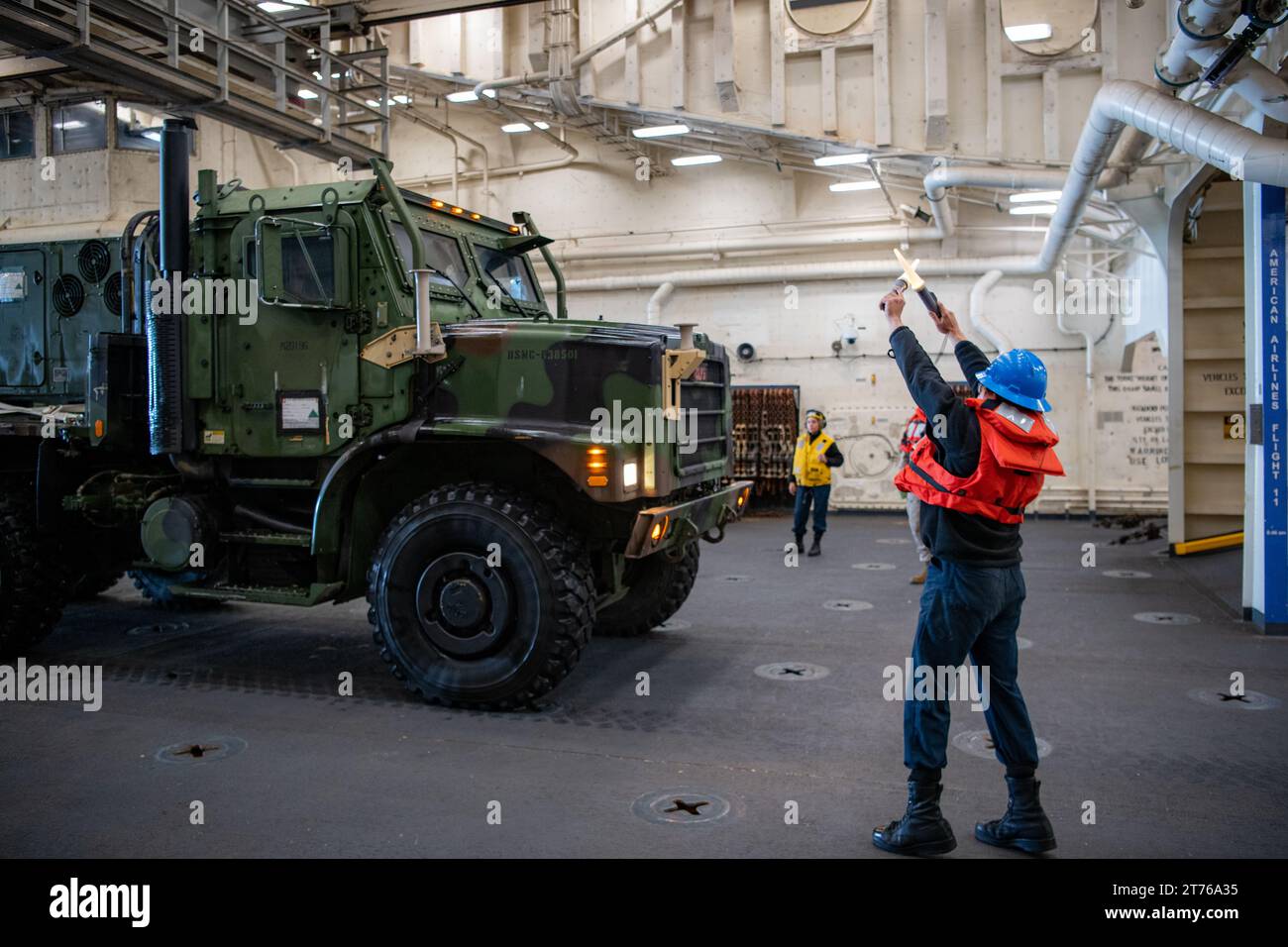 Seaman Ricky Smith, a native of Denver, signals a medium tactical ...