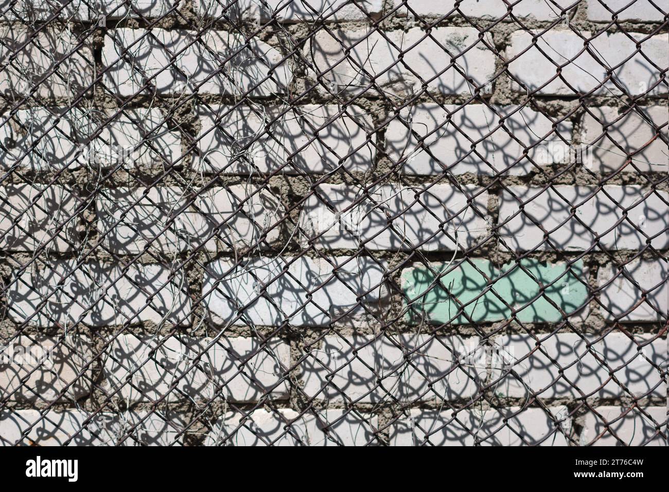 Rusty steel wire mesh on a brick wall. Background texture Stock Photo ...
