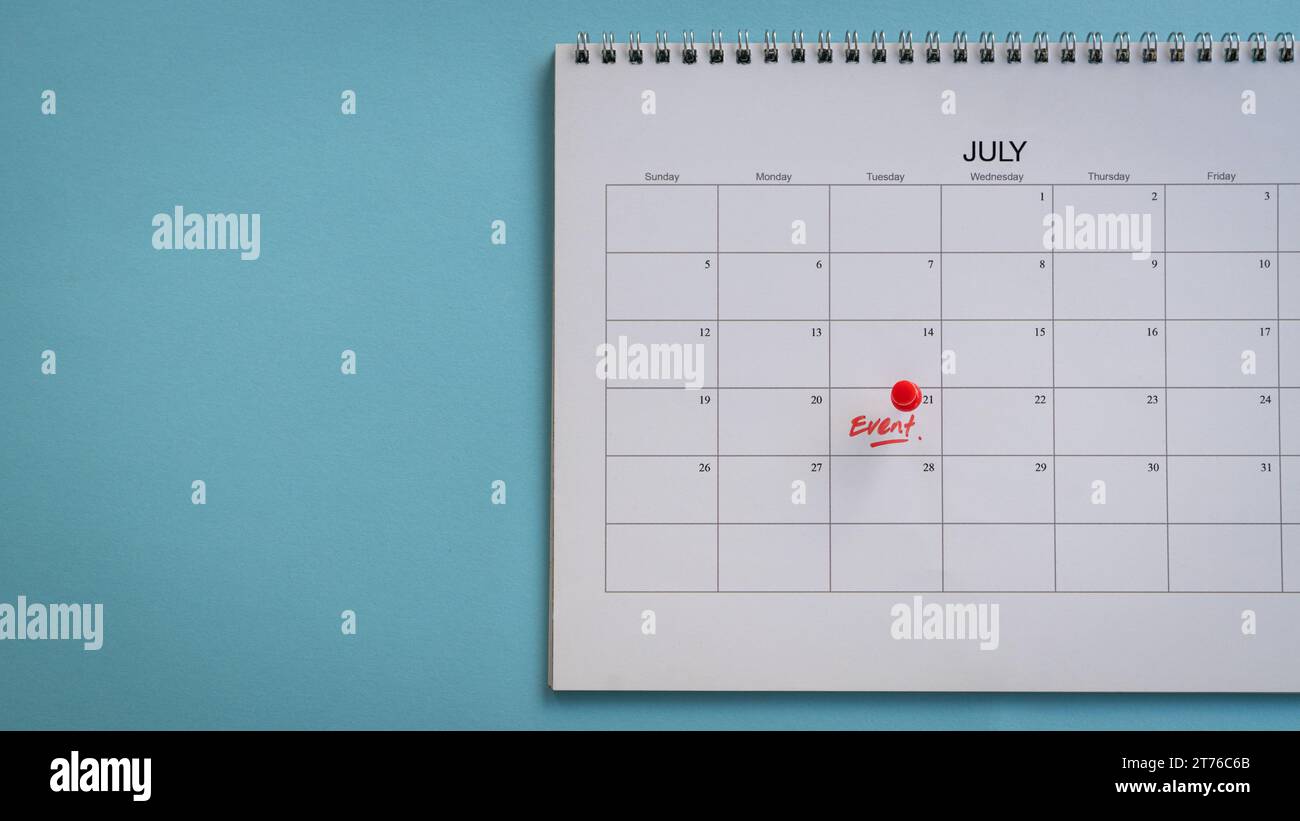 Calendar with word event and red pushpin. On blue desk background, copy ...