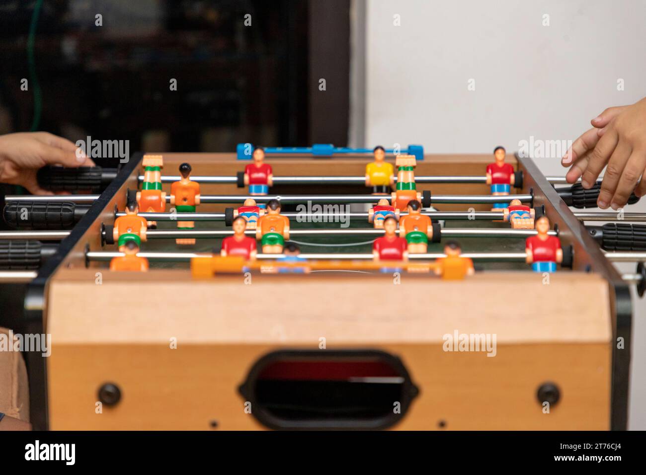 Two children having fun playing table football together Stock Photo - Alamy