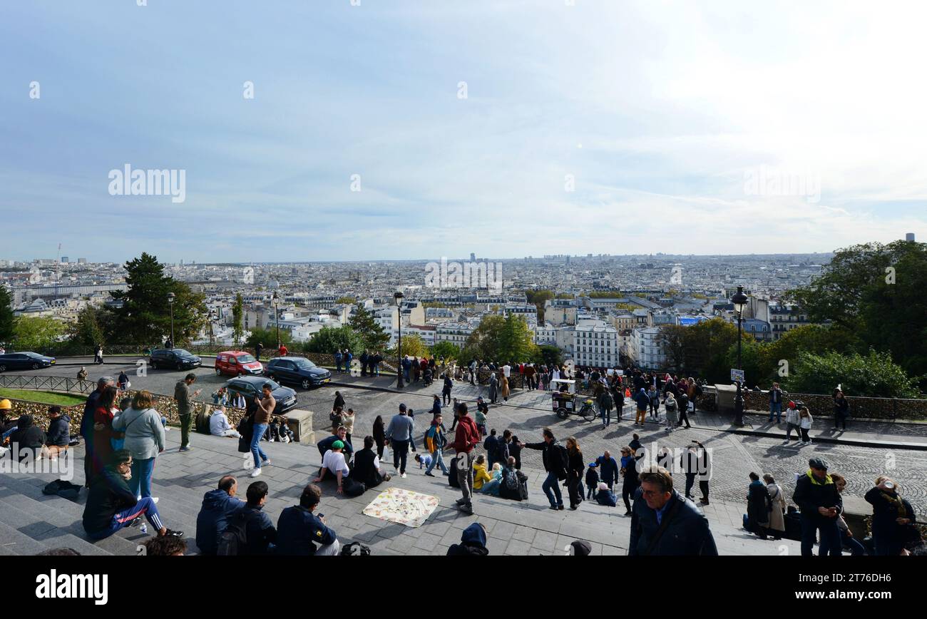 Tourist enjoying the views of Paris from the steps below the Basilica ...