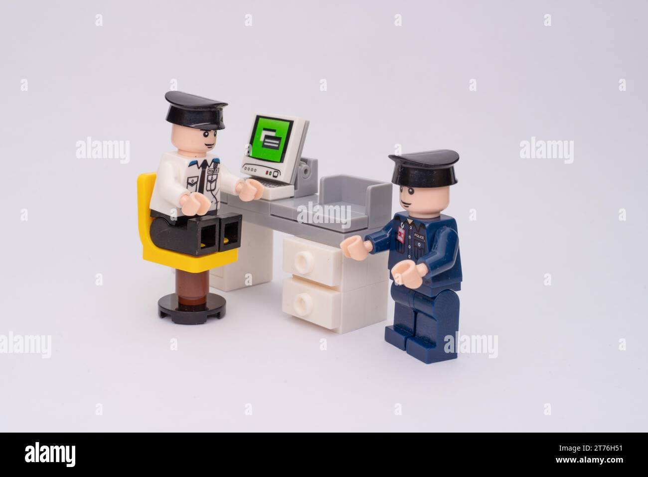 The two miniature police officer figurines working in front of a ...