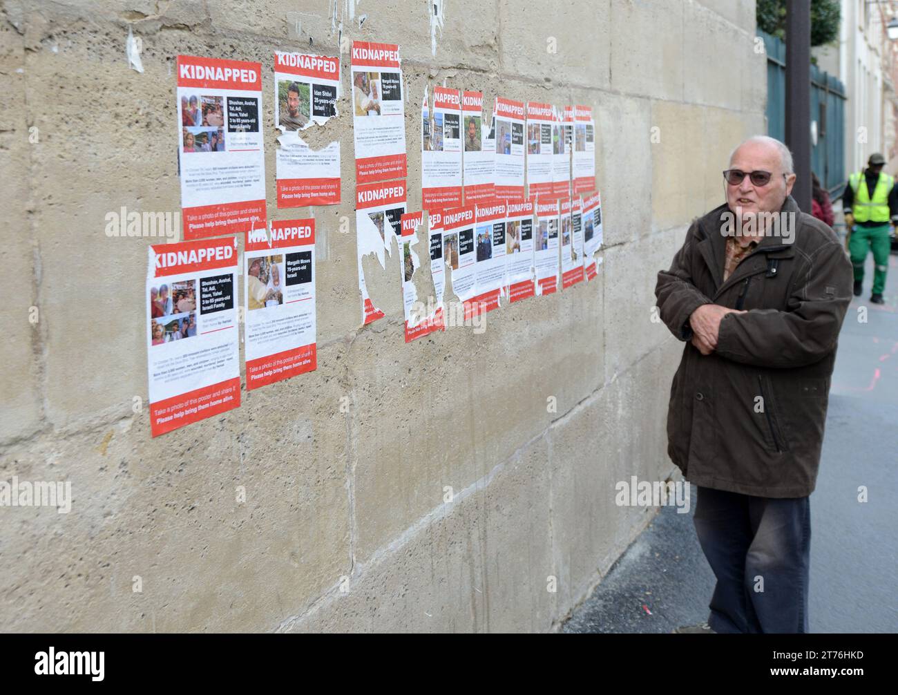 A French man looking at the Israeli hostages kidnapped signs on walls ...