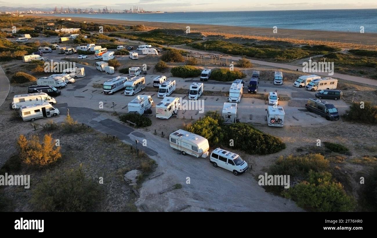 An overhead aerial view of a campsite near a beach, taken during dusk ...