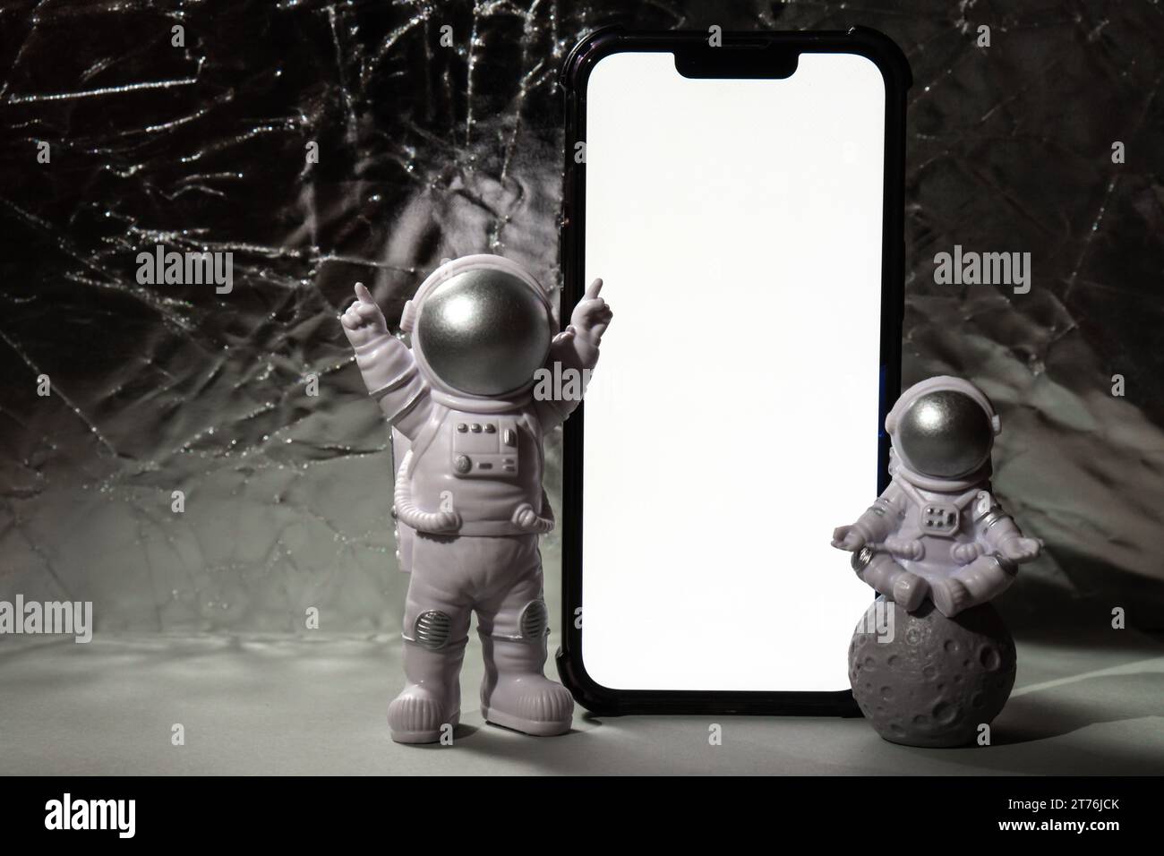 Plastic toy figure astronaut with mobile phone white screen for your ...