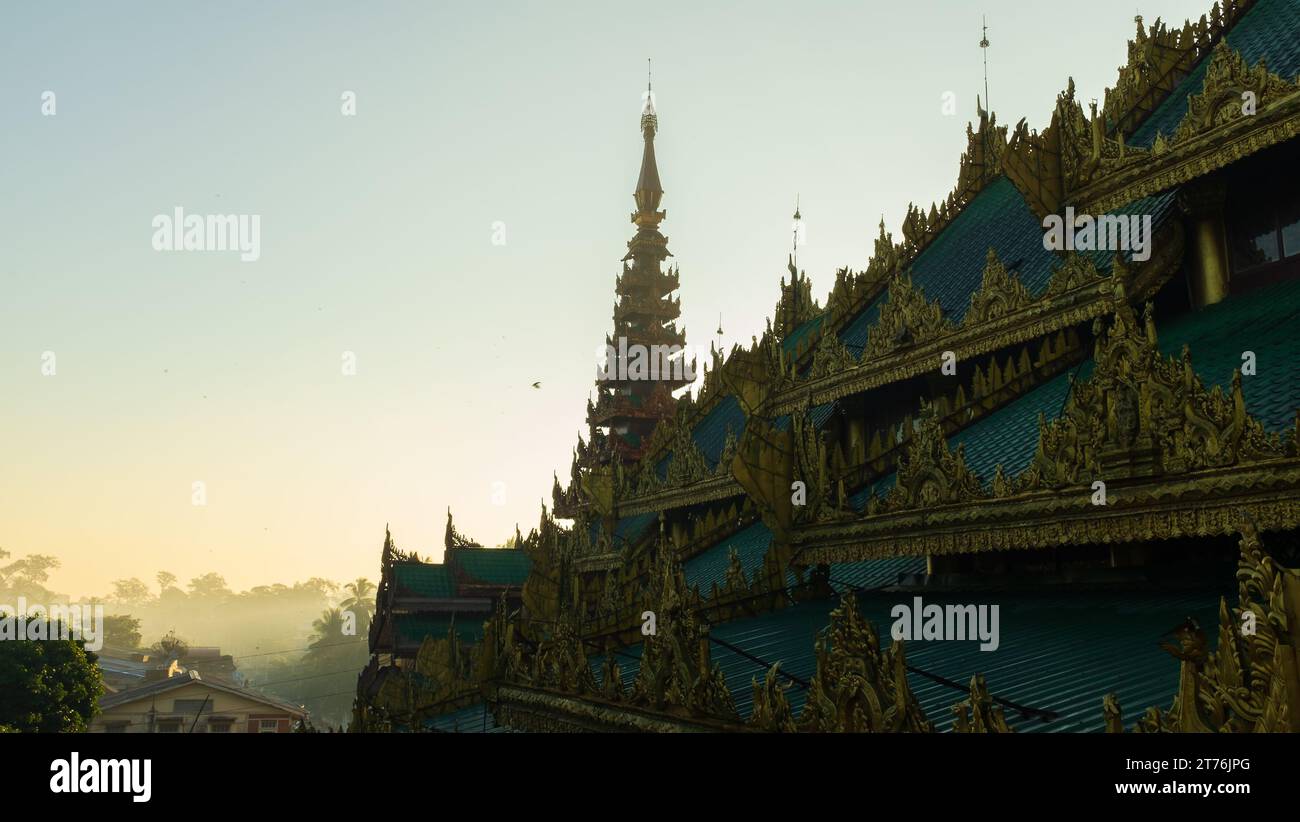 Yangon, Myanmar. At the Shwedagon Pagoda, the green roofs of a covered ...