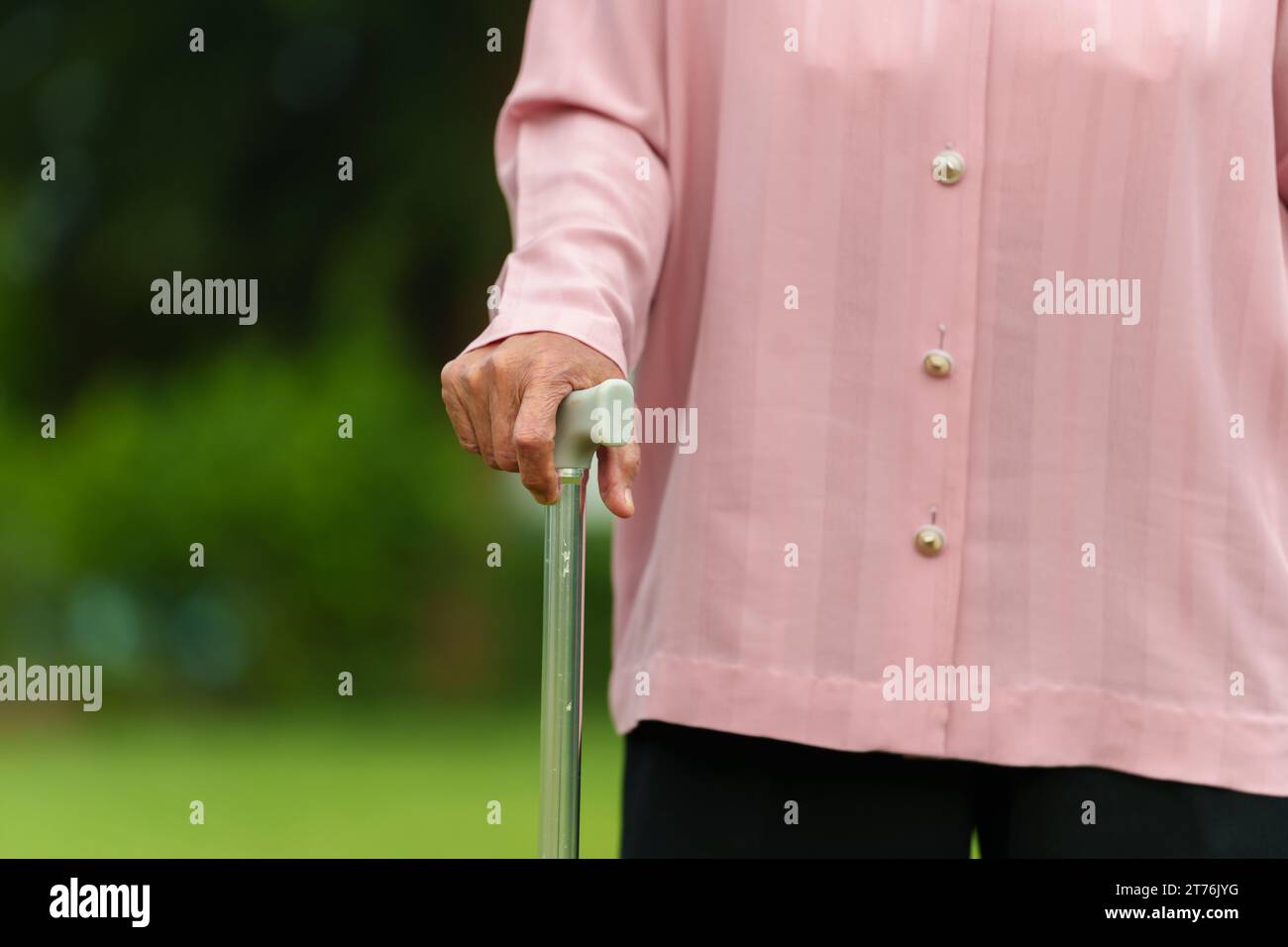 Older woman with walking stick hi-res stock photography and images - Alamy