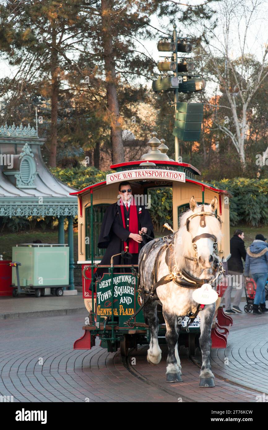 A man harnessing a horse carriage on a cobblestone street in Paris ...