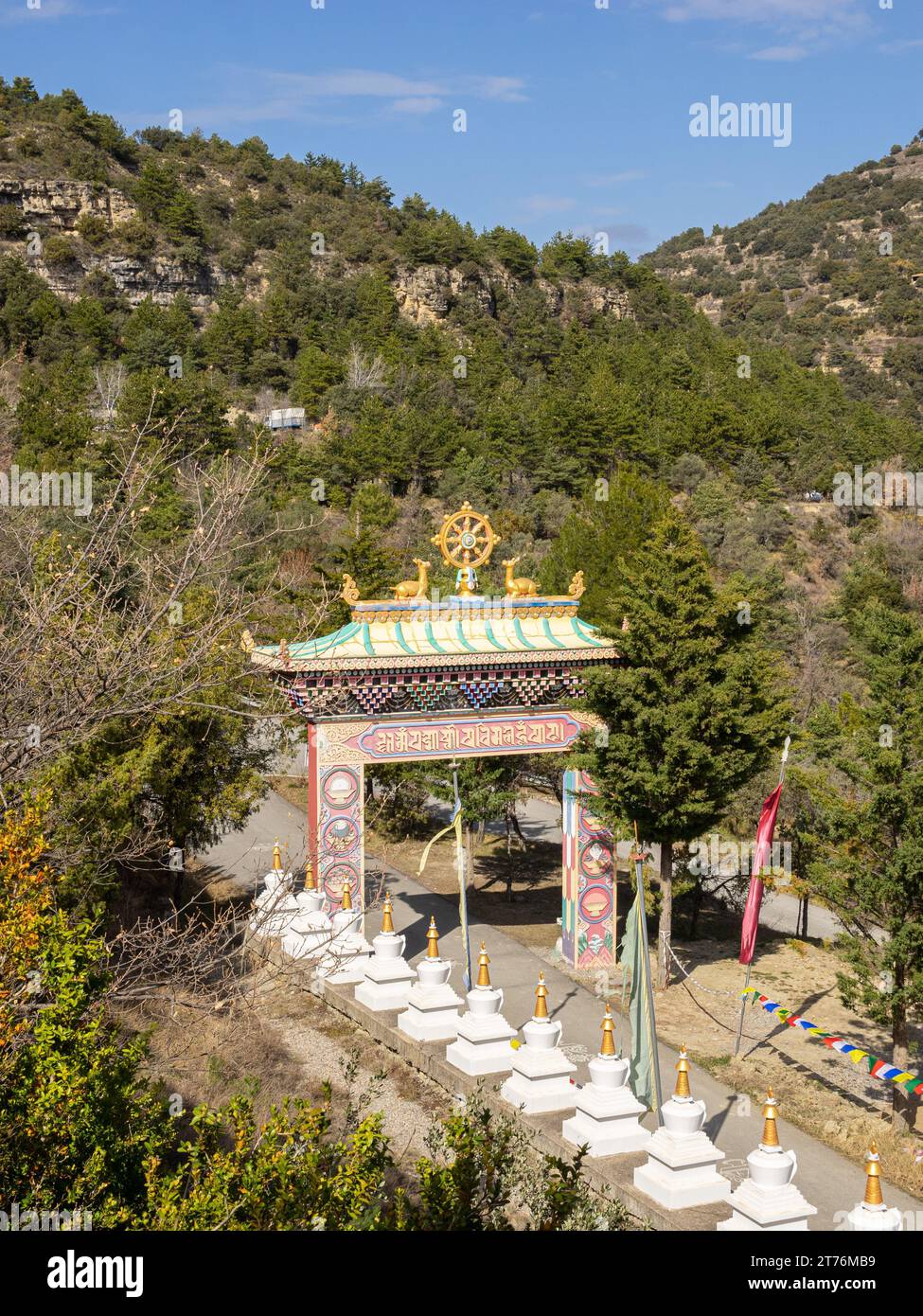 An ornate religious arch stands against a white wall, adorned with ...
