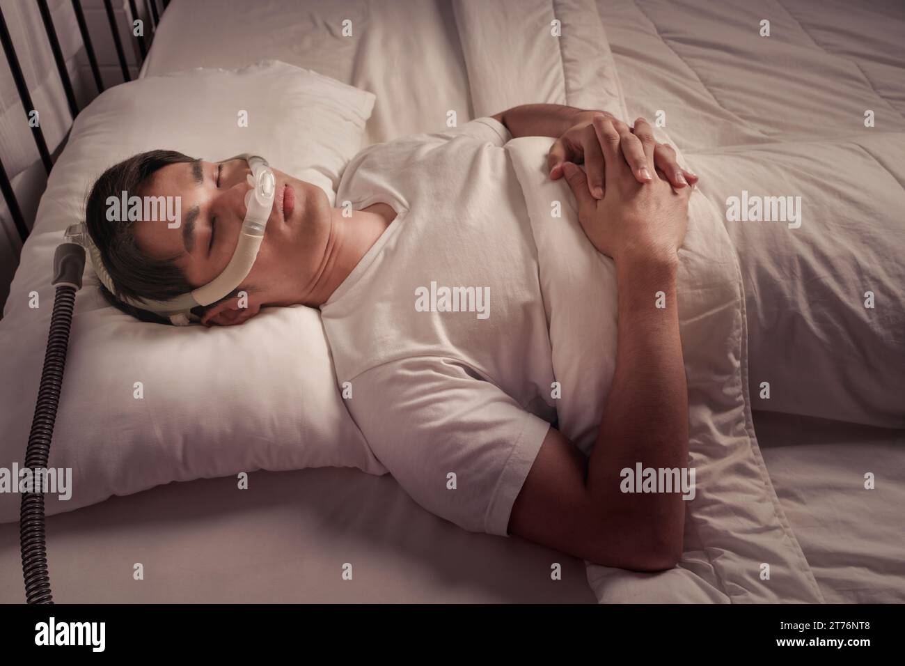 Peaceful Asian male asleep using CPAP mask and machine for obstructive ...