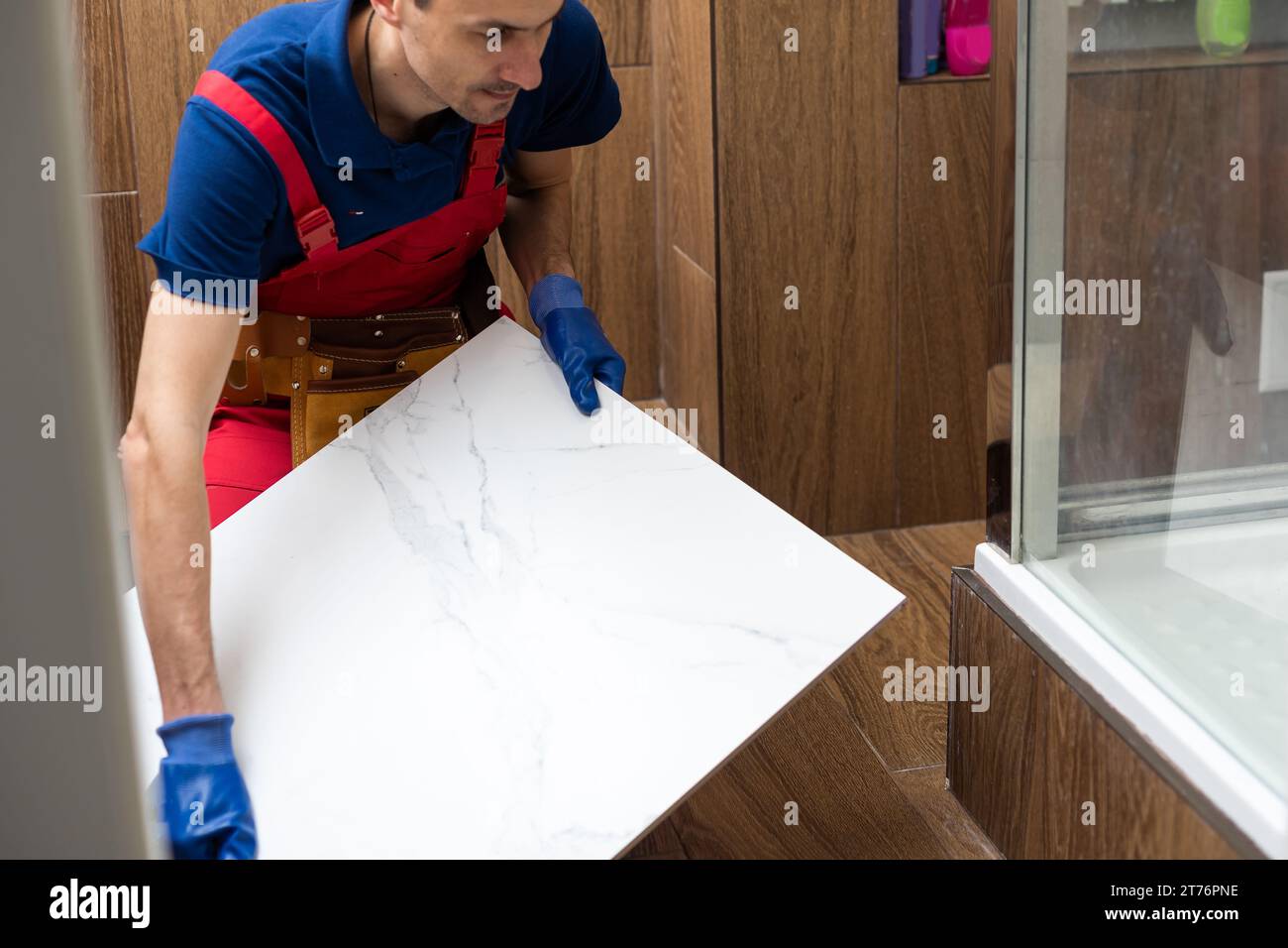 Industrial tiler builder worker installing floor tile at repair ...