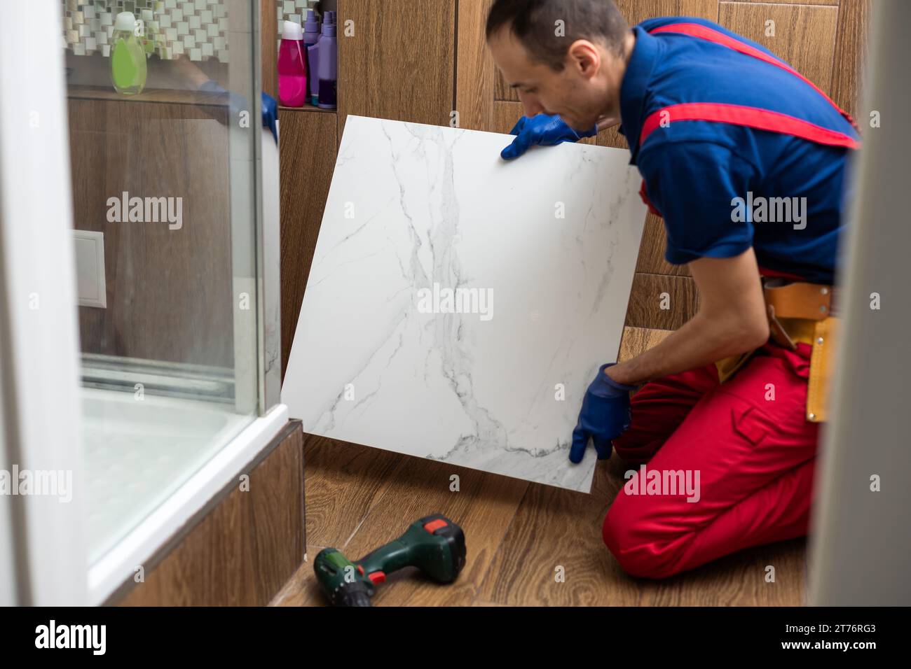 Home improvement, renovation - construction worker tiler is tiling ...