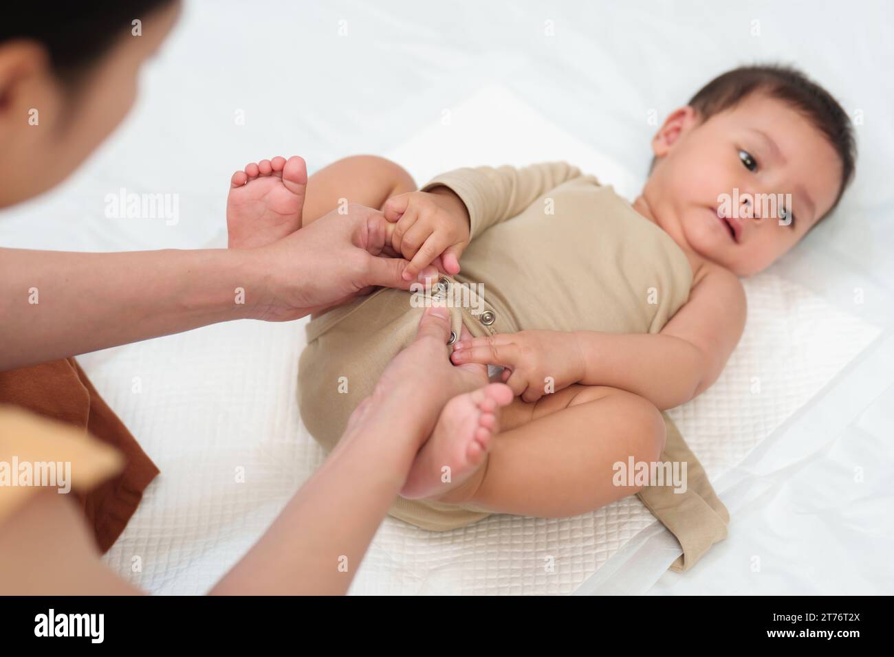 mother with her infant baby during changing the clothes Stock Photo - Alamy